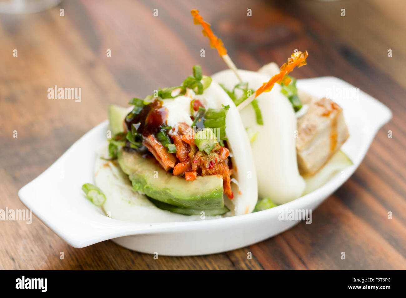 Korean steamed buns with pork belly avokado and kimchi Stock Photo - Alamy