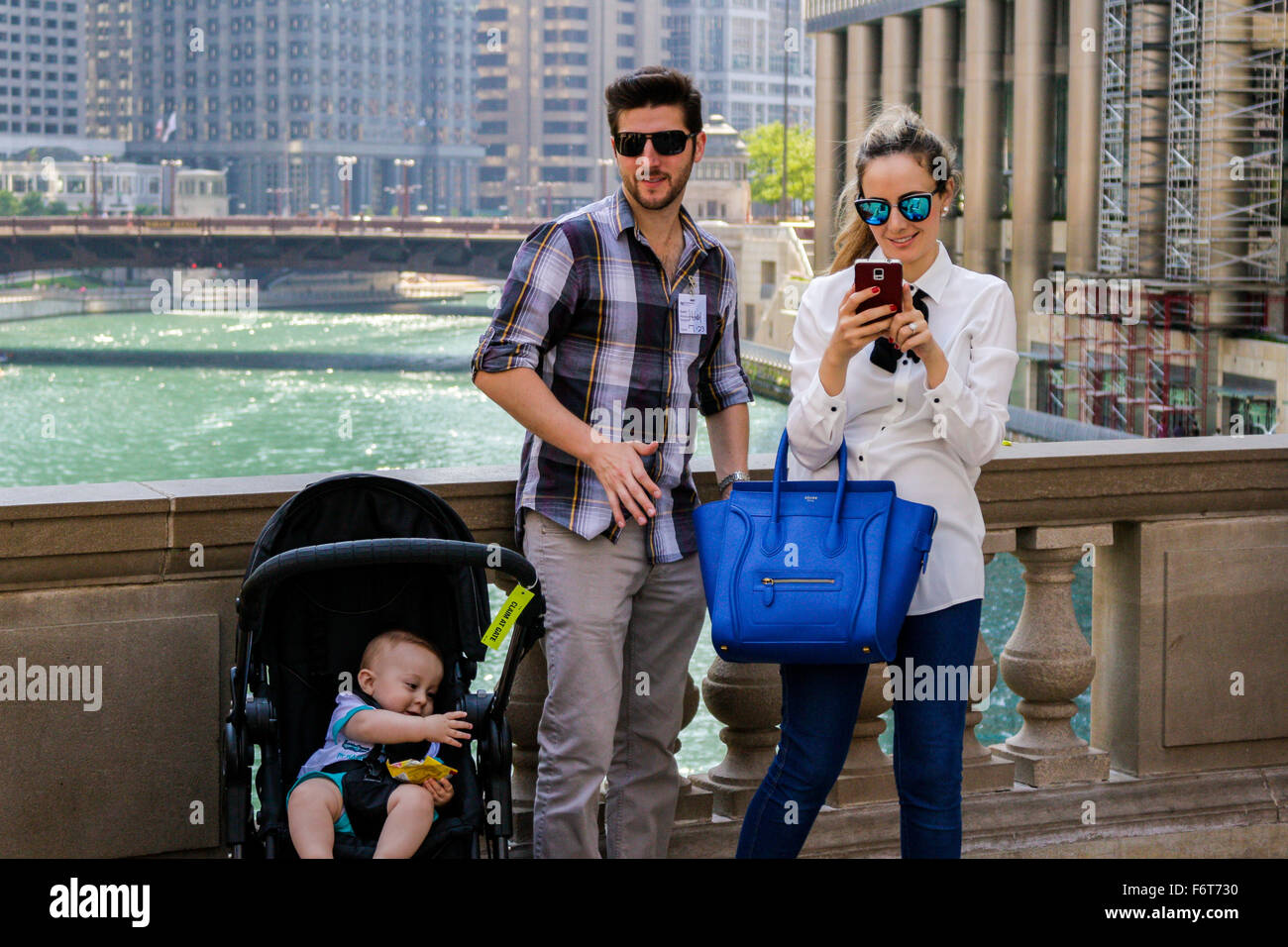 Young couple with baby in stroller. Near Michigan Avenue Bridge ...