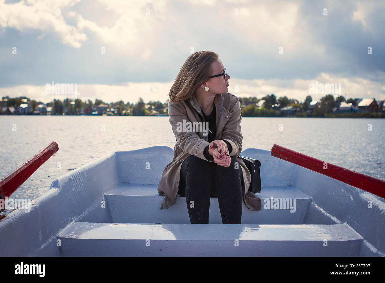 Caucasian woman sitting in rowboat Stock Photo - Alamy