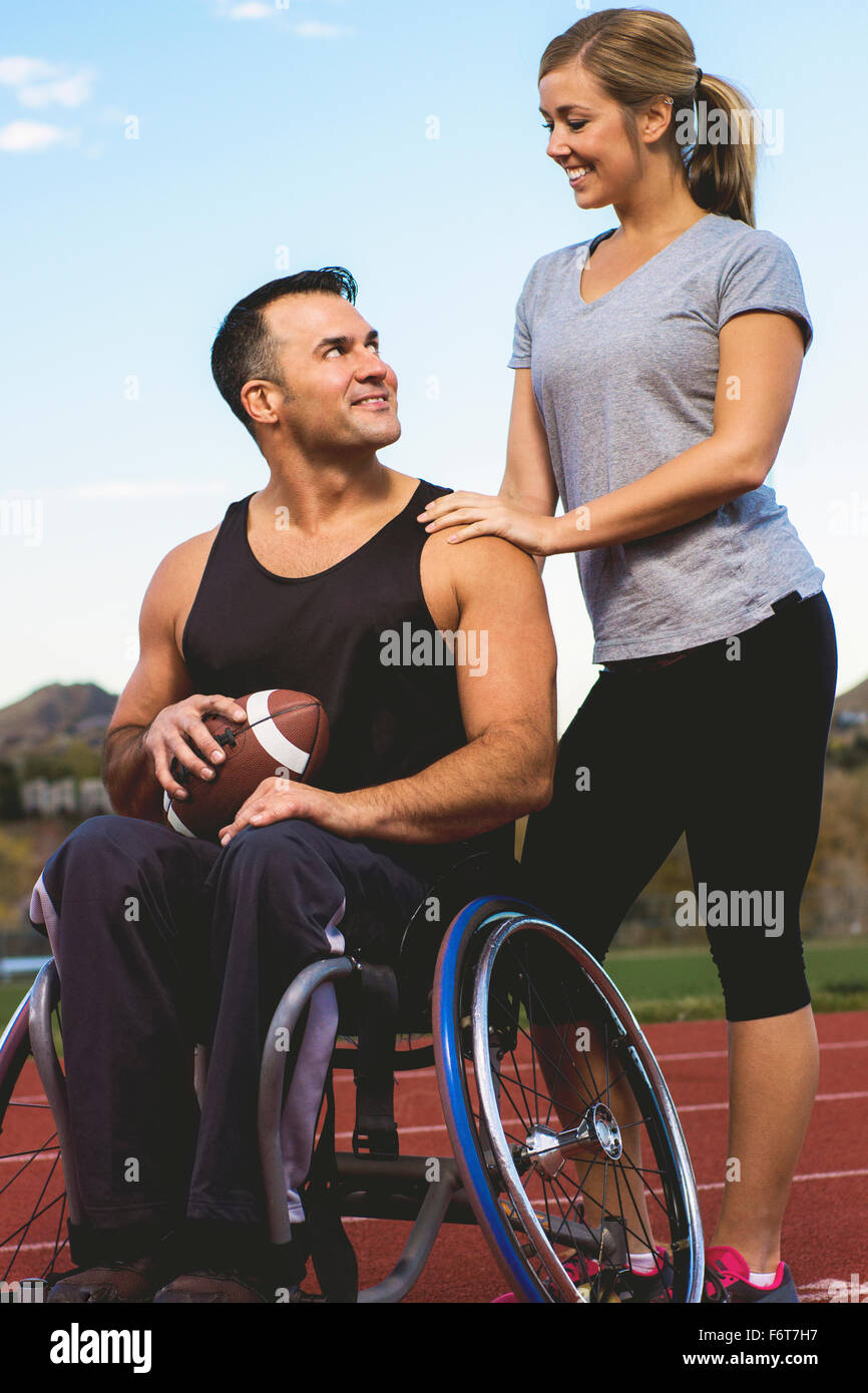 Paraplegic athlete in wheelchair with girlfriend Stock Photo - Alamy