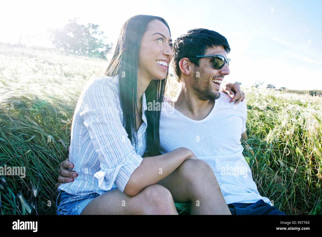 Couple hugging in field Stock Photo - Alamy