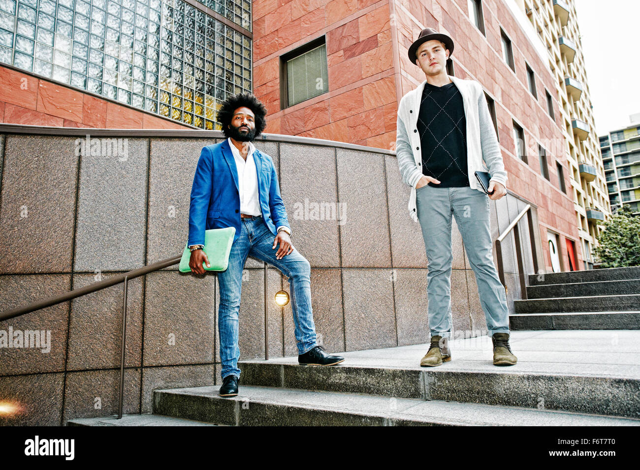 Businessmen standing on steps Stock Photo - Alamy