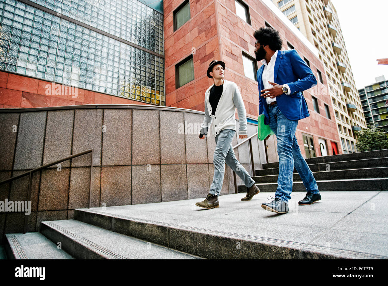 Businessmen talking on steps Stock Photo - Alamy