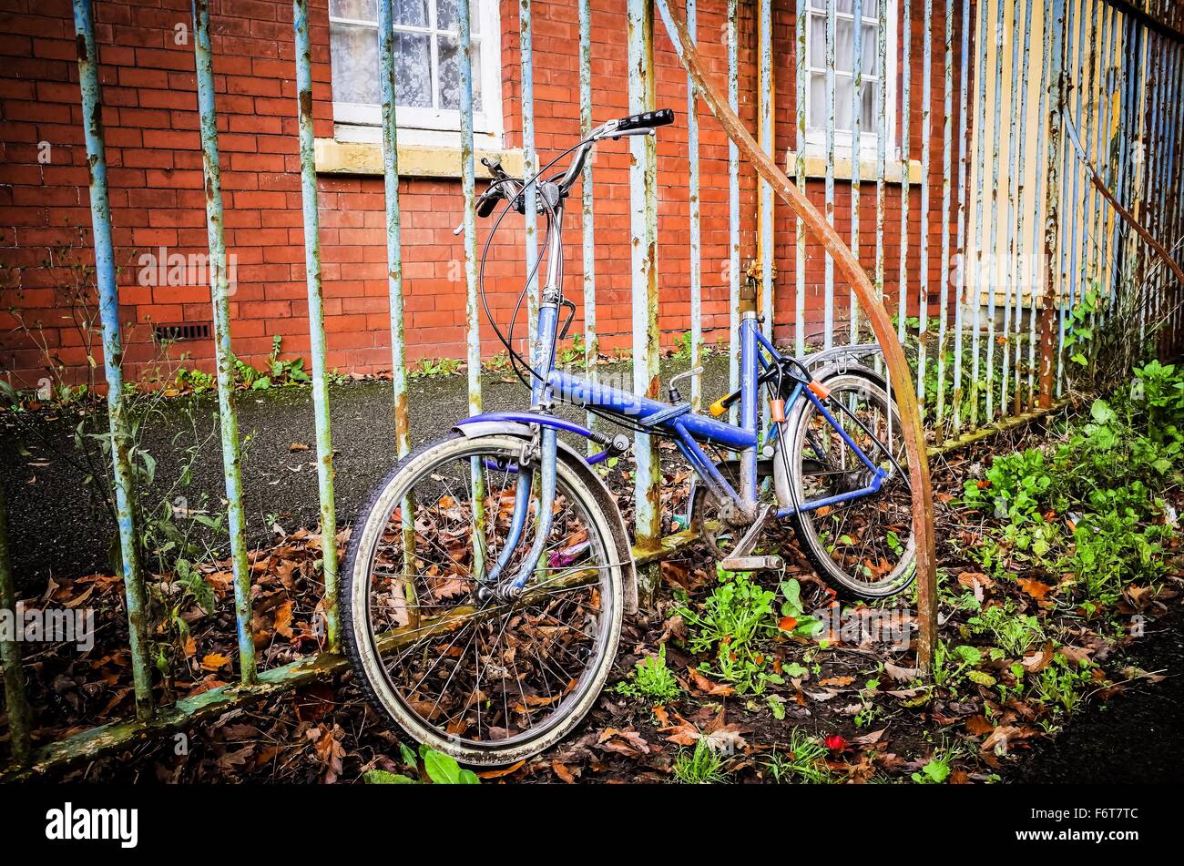 Bike chained to an old railings and forgotten about Stock Photo - Alamy
