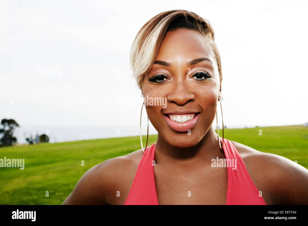 Black woman smiling in field Stock Photo - Alamy