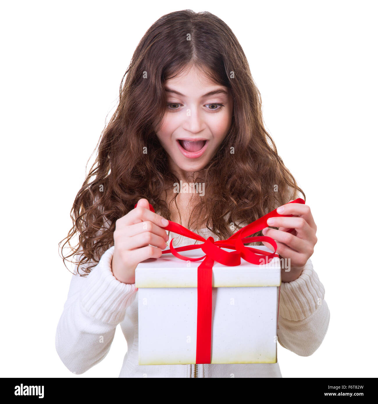 Portrait of cute cheerful teen girl receiving gift, excited facial ...