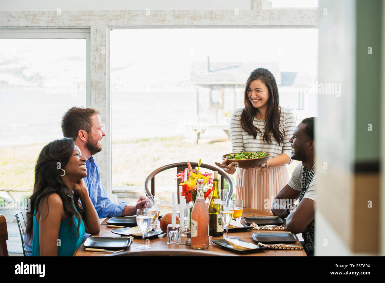 Woman serving friends at dinner party Stock Photo - Alamy
