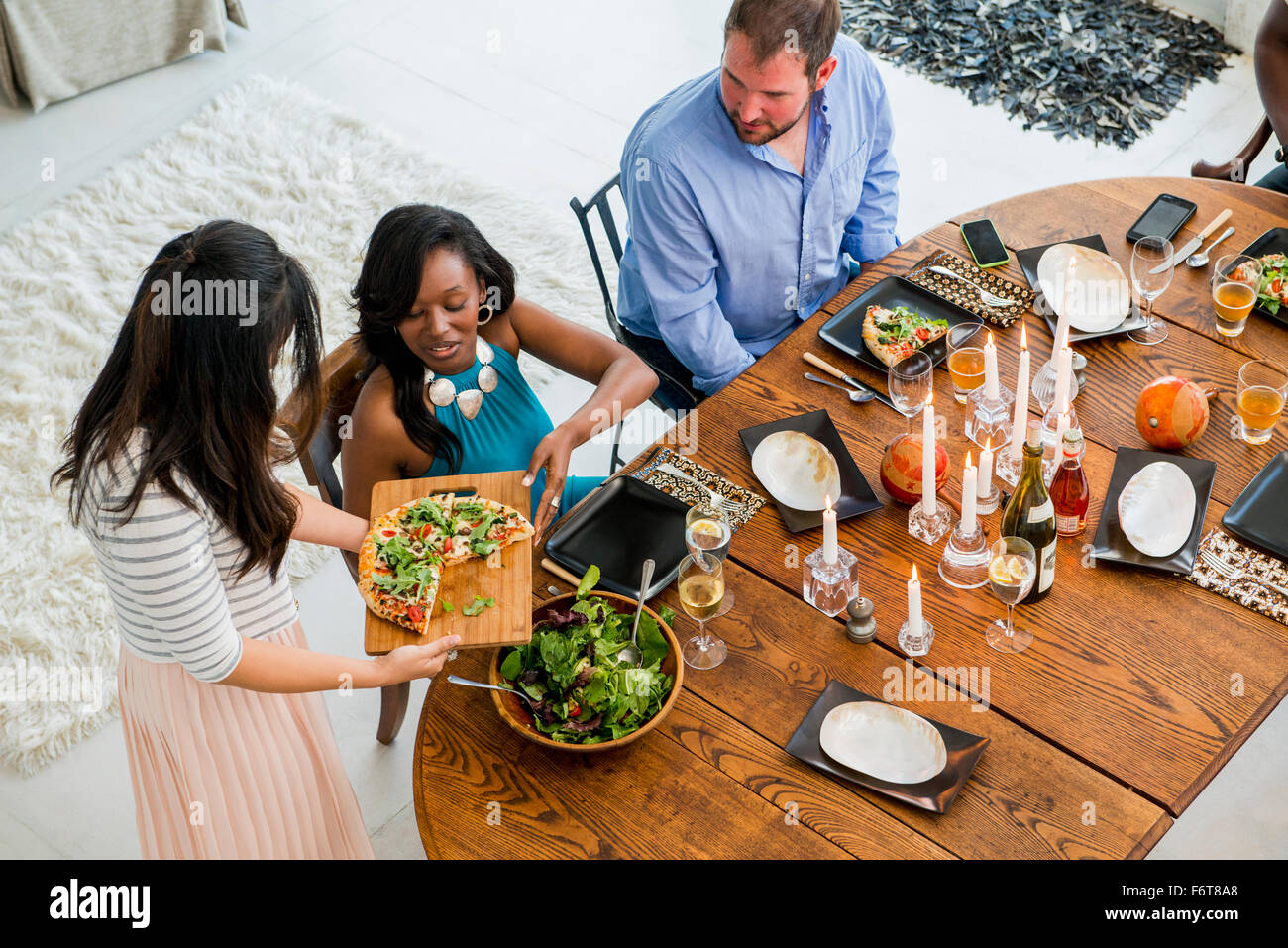 Young woman serving table hi-res stock photography and images - Alamy