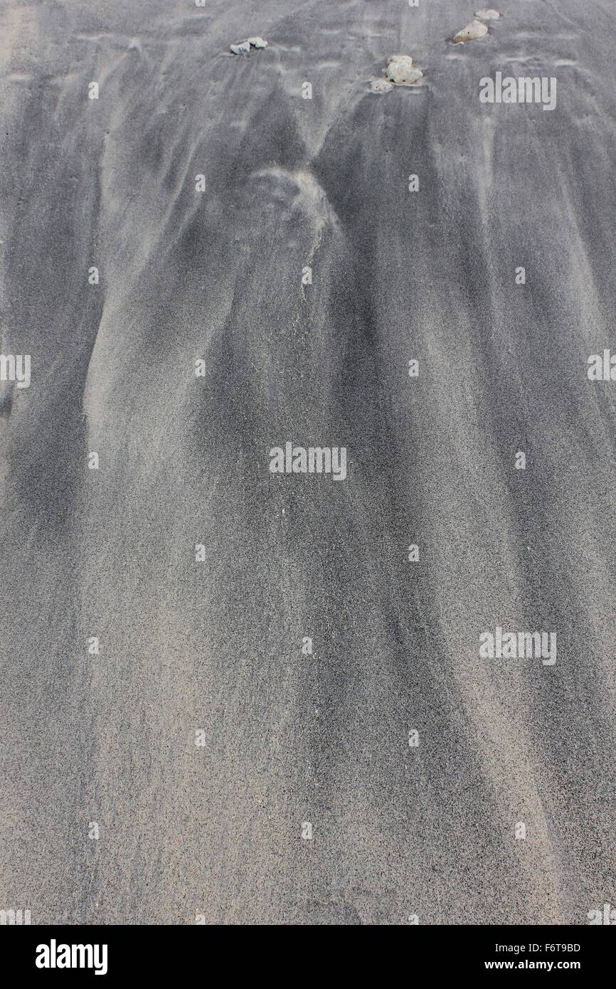 The merge of white and black sand on Indonesian beach shoreline Stock ...