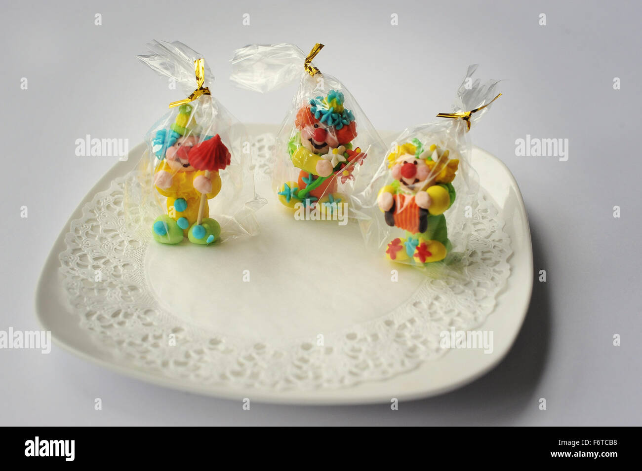 sweet candies of three clowns food isolated on white Stock Photo - Alamy