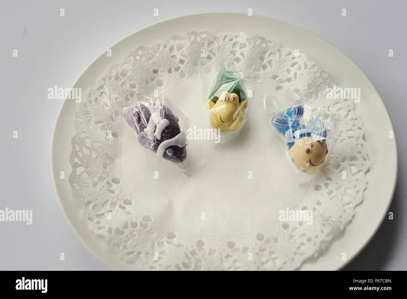 sweet candies of three fish food isolated on white Stock Photo - Alamy
