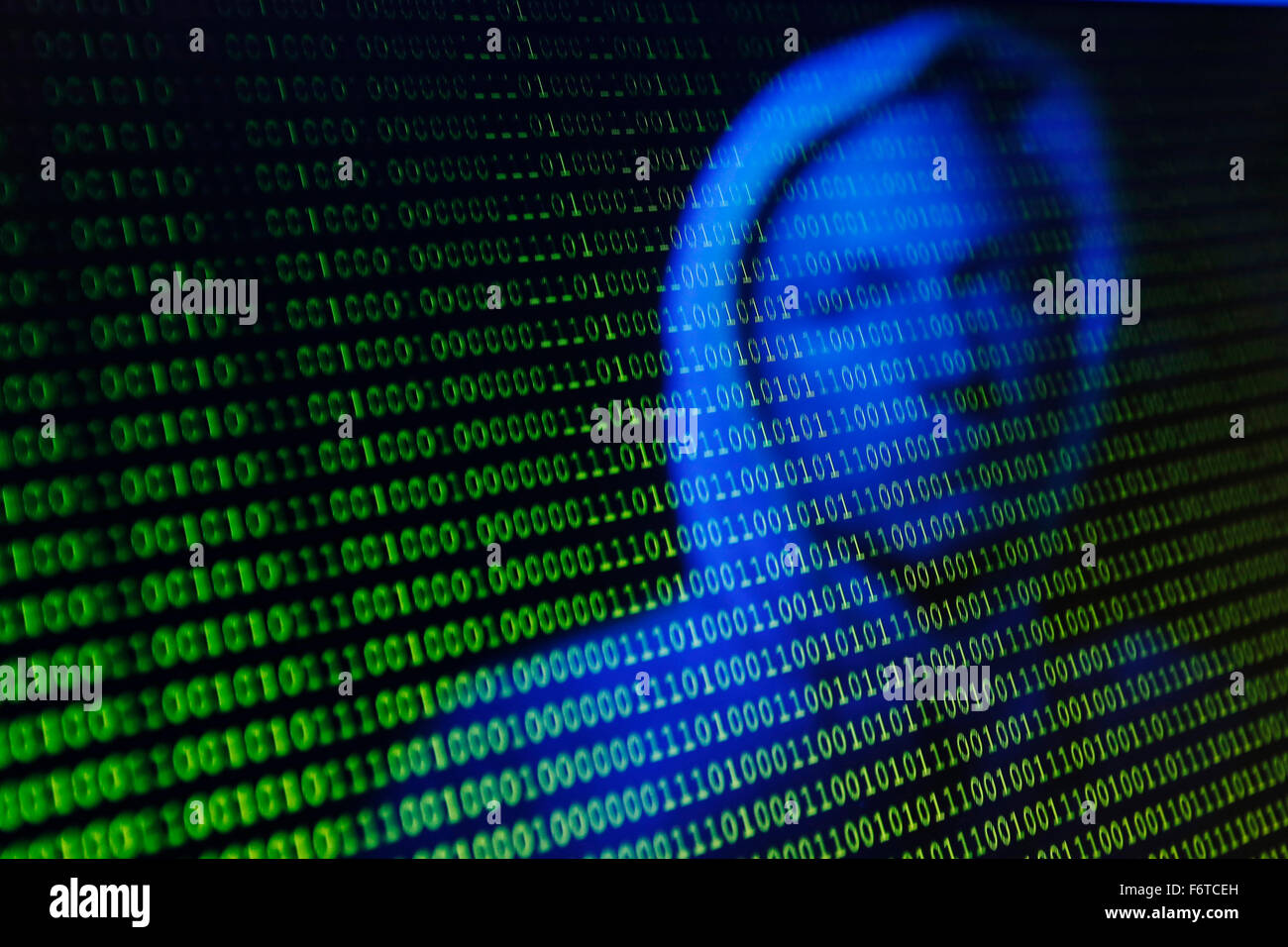 A face is reflected into a computer screen with binary type Stock Photo ...