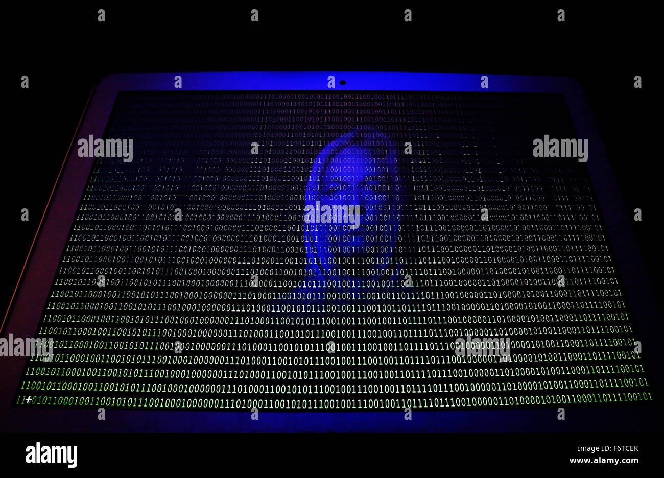 A face is reflected into a computer screen with binary type Stock Photo ...