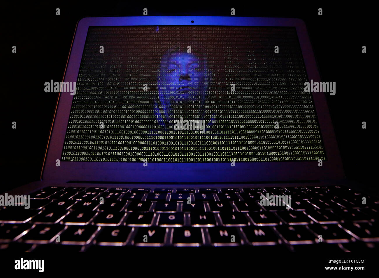 A face is reflected into a computer screen with binary type Stock Photo ...