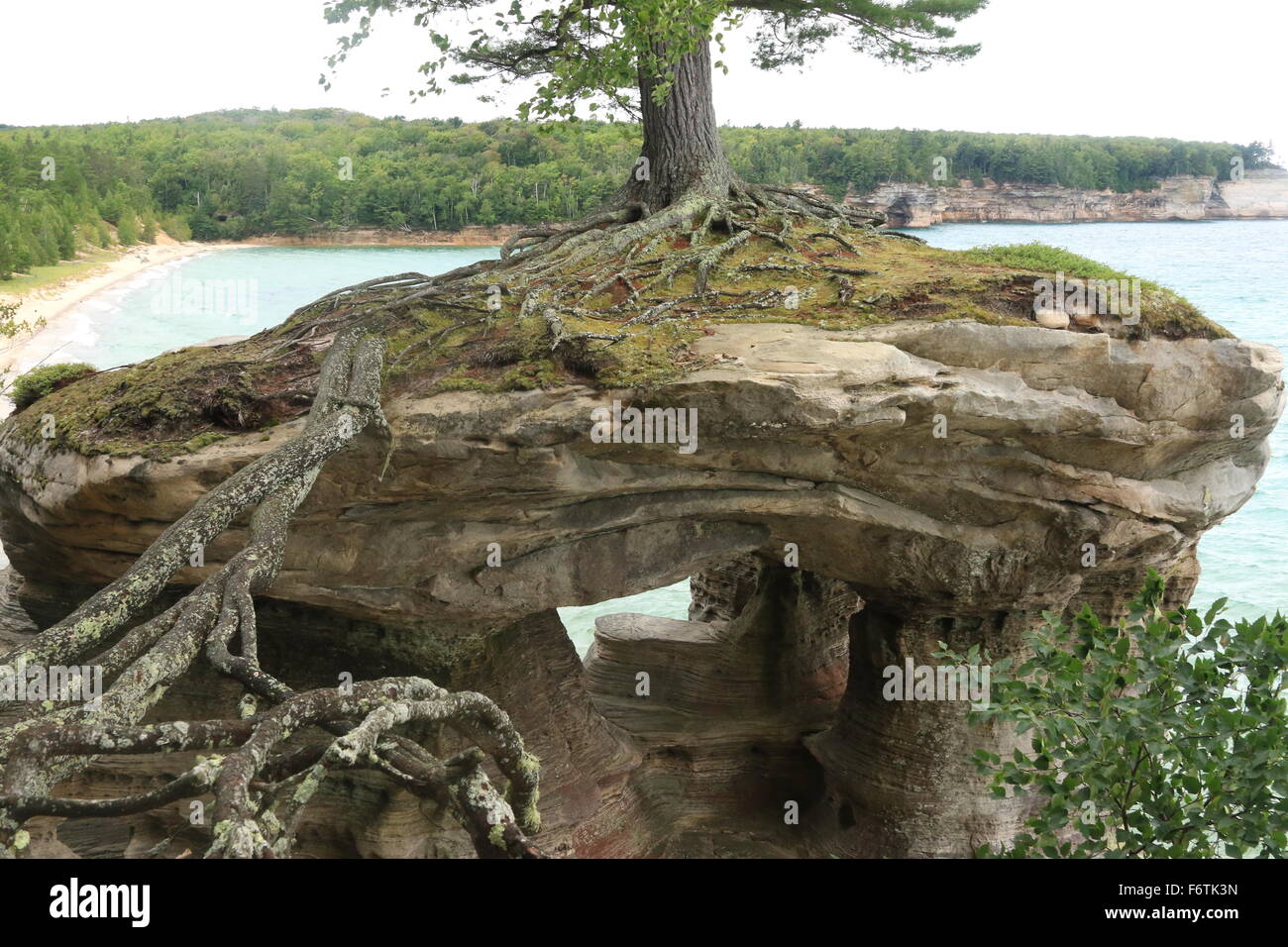 Chapel rock rock formation and tree roots on chapel beach along lake ...