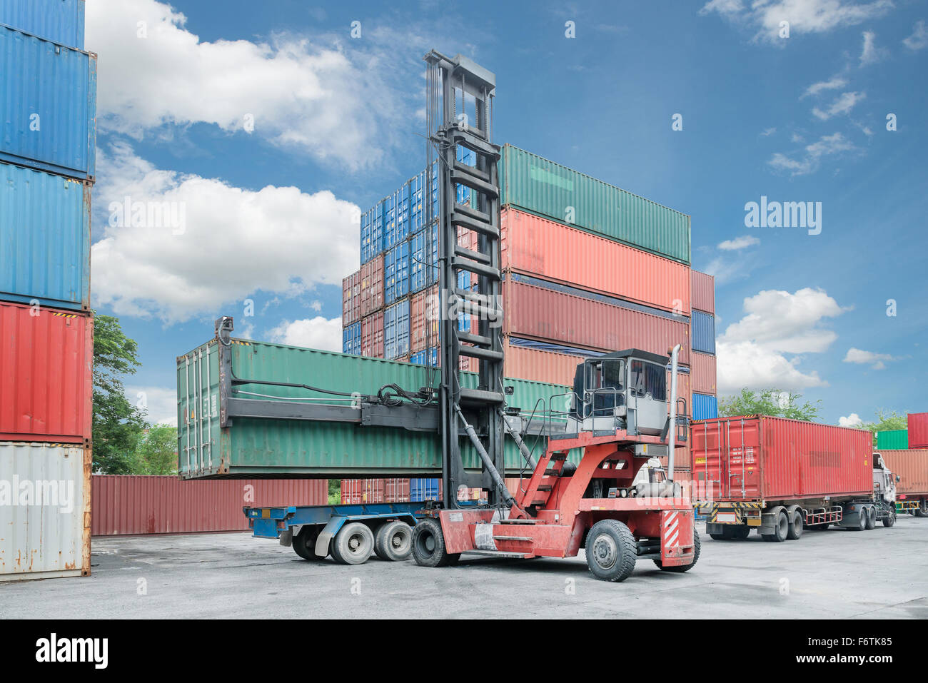 Crane lifter handling container box loading to truck Stock Photo - Alamy