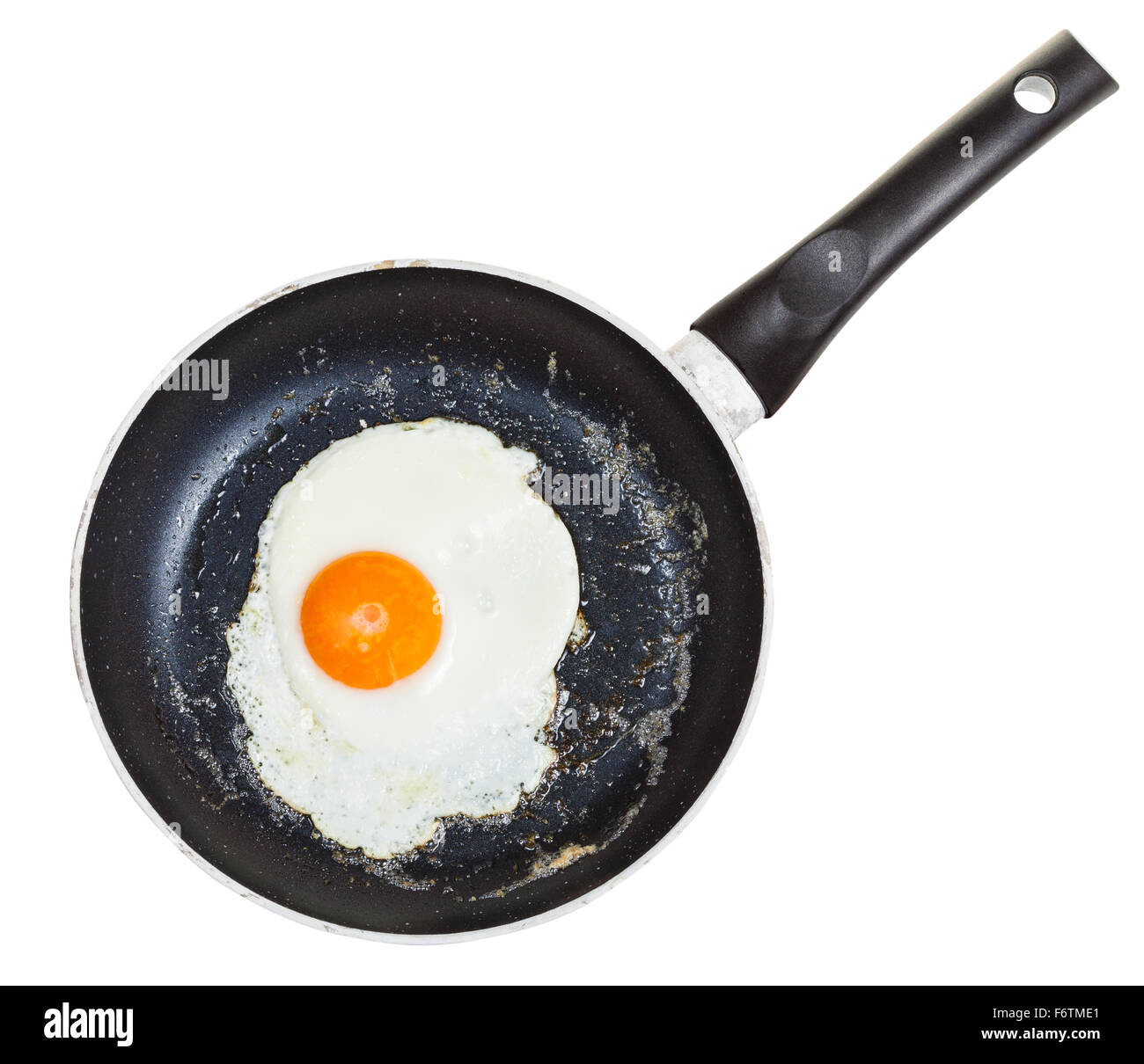 top view of one fried egg in black frypan isolated on white background ...