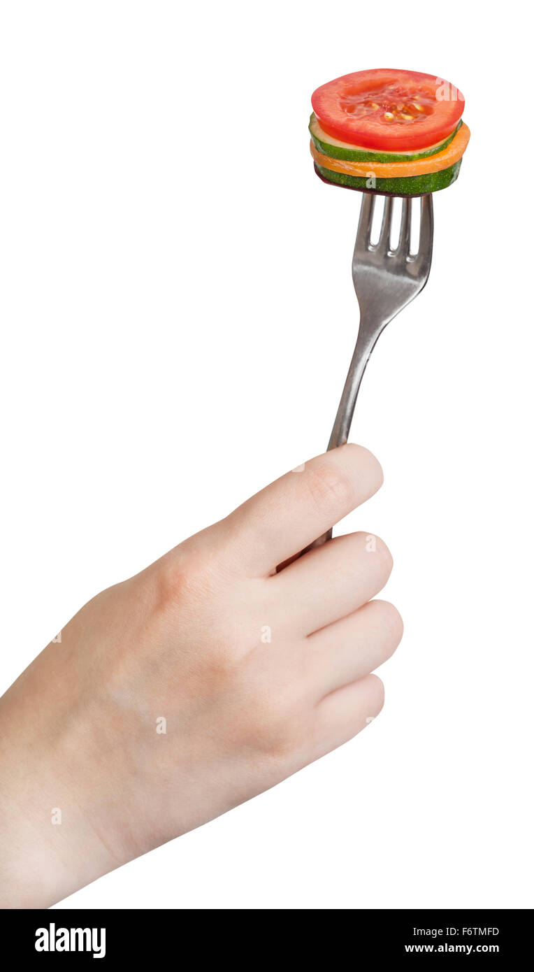 hand holding dinning fork with fresh sliced vegetables isolated on ...