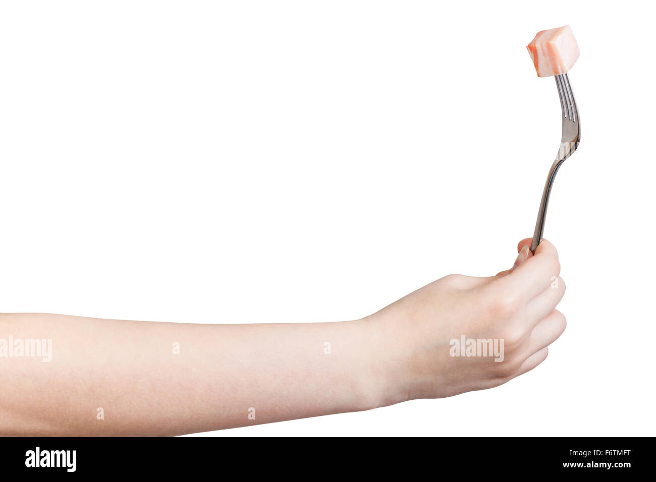 hand holds fork with impaled piece of lard isolated on white background ...