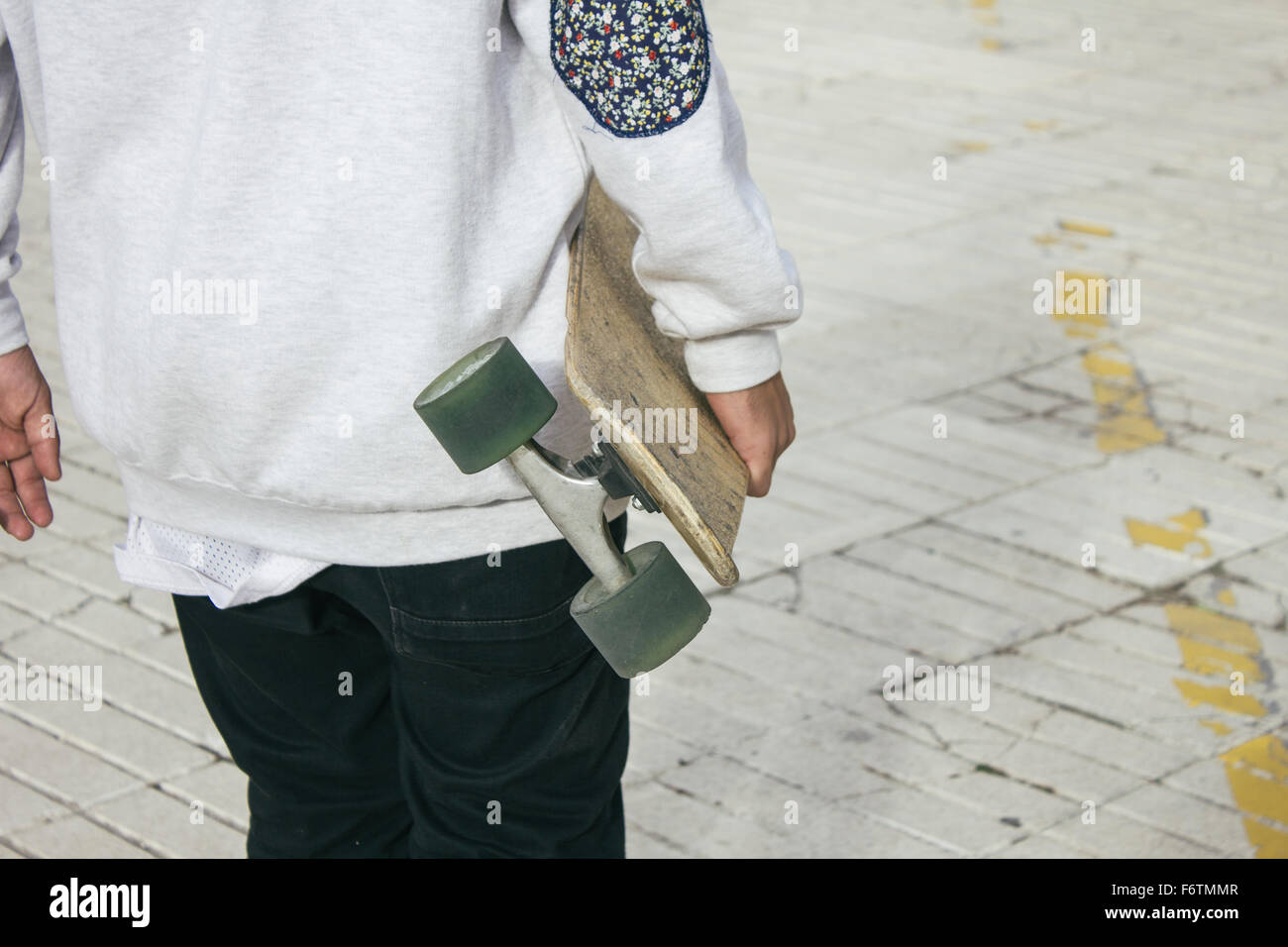 Young man carrying his longboard Stock Photo - Alamy