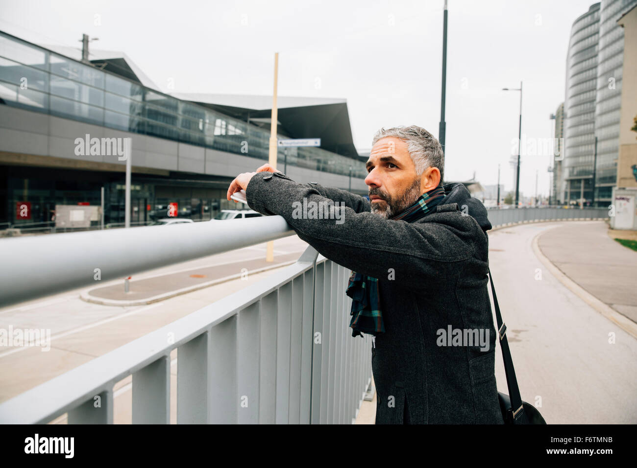 Austria, Vienna, man leaning on a railing near central station Stock ...