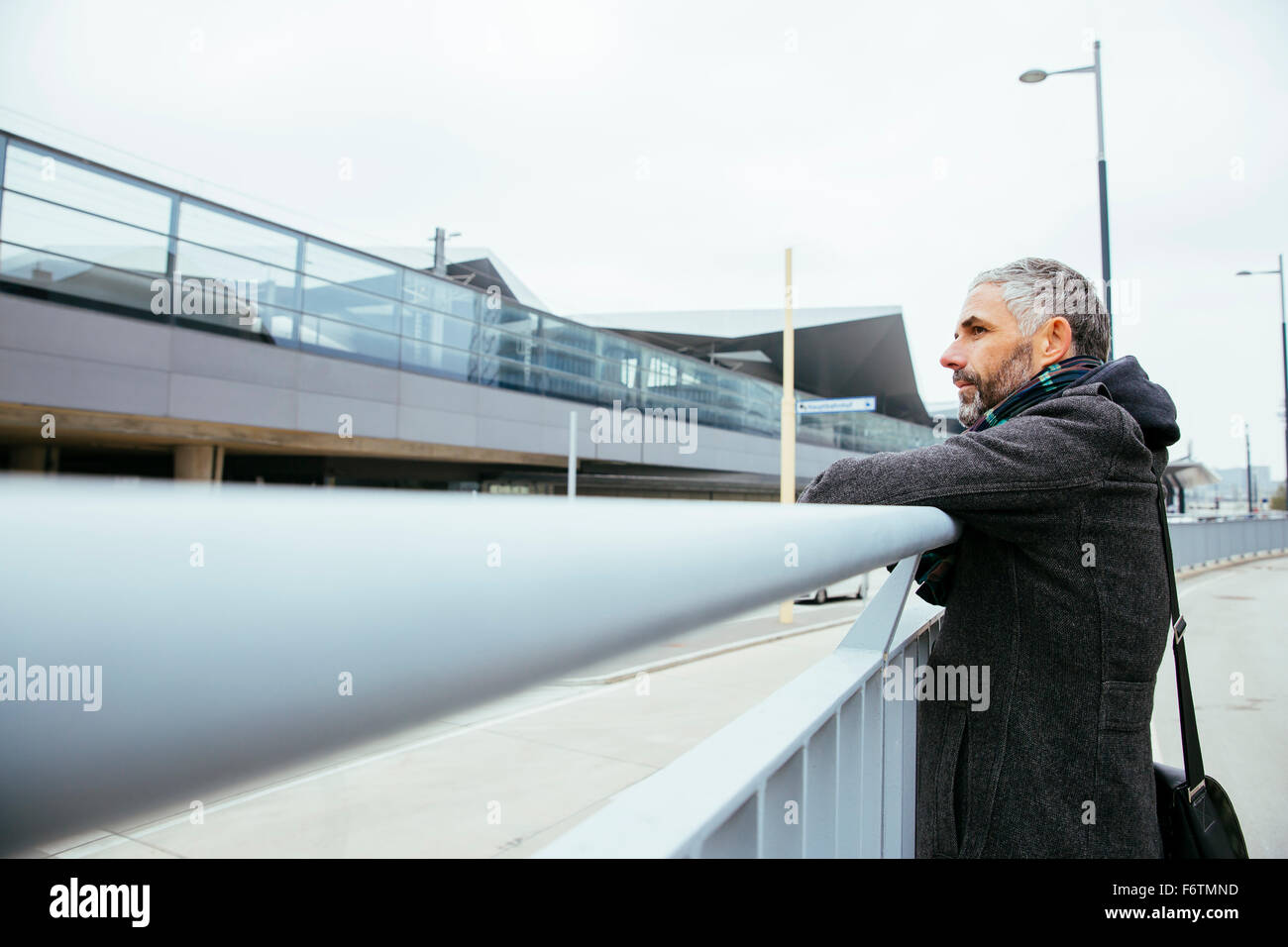 Austria, Vienna, man leaning on a railing near central station Stock ...