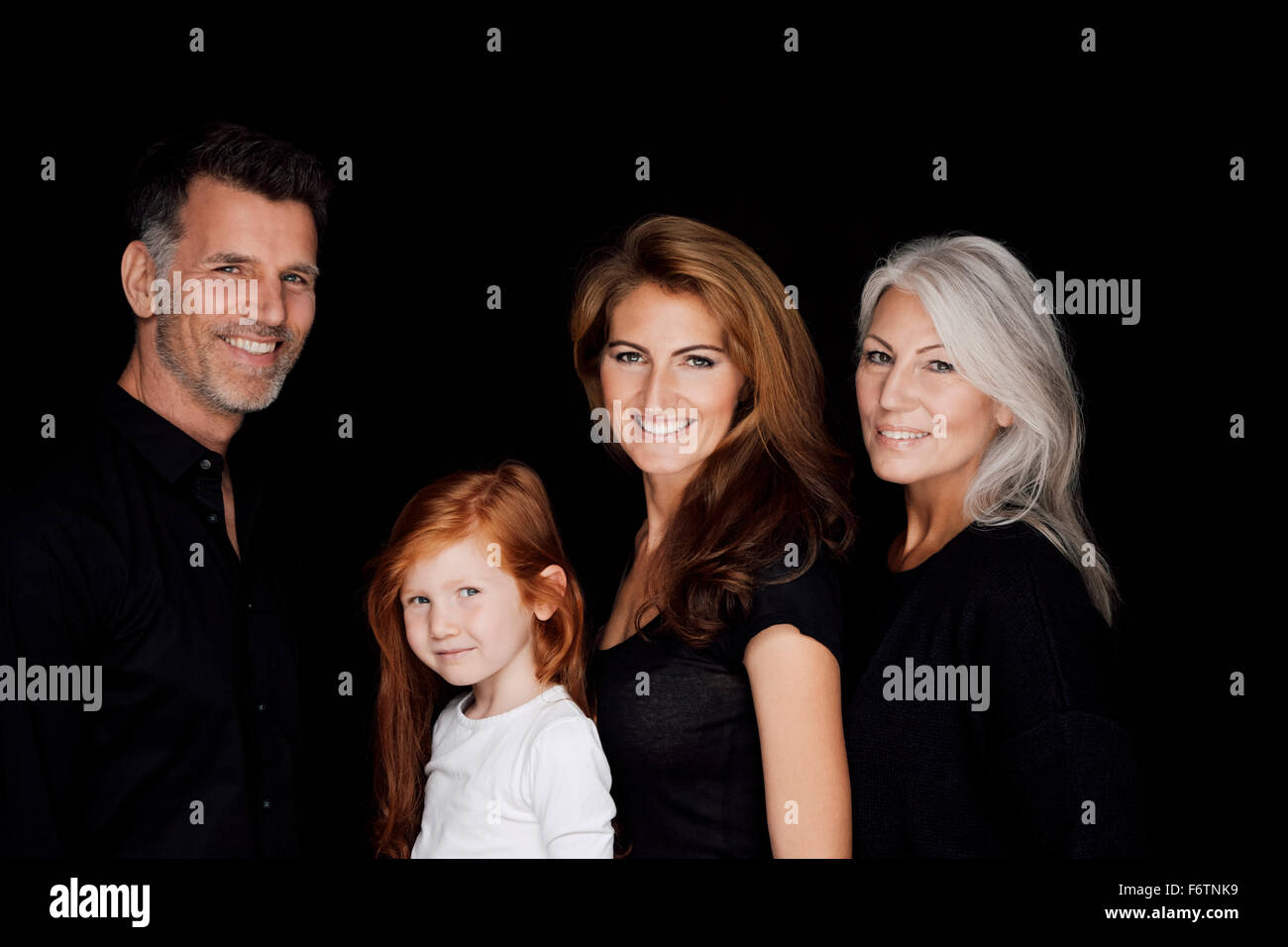 Portrait of three generations family in front of black background Stock ...
