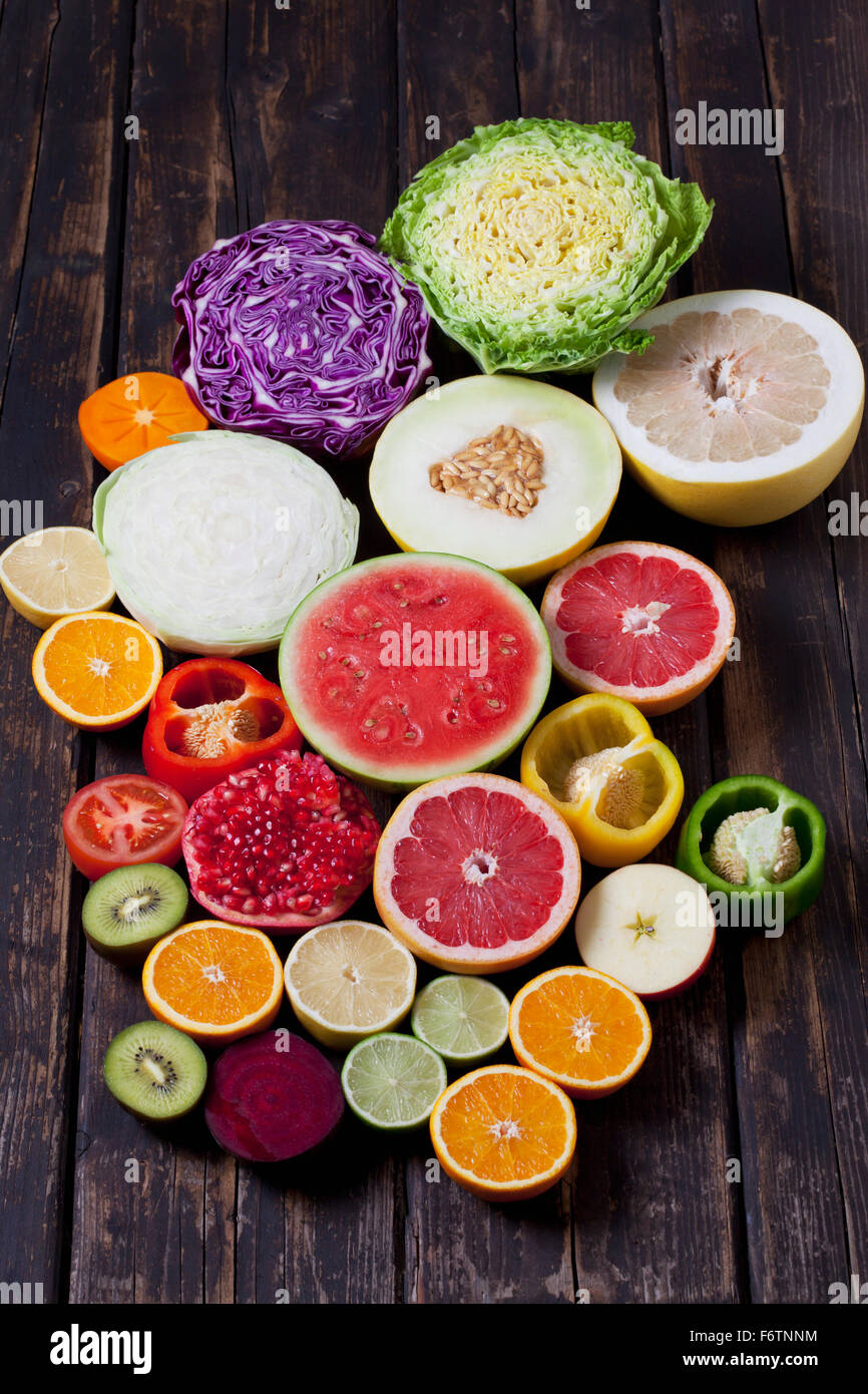 Halves of different vegetables and fruits on dark wood Stock Photo - Alamy
