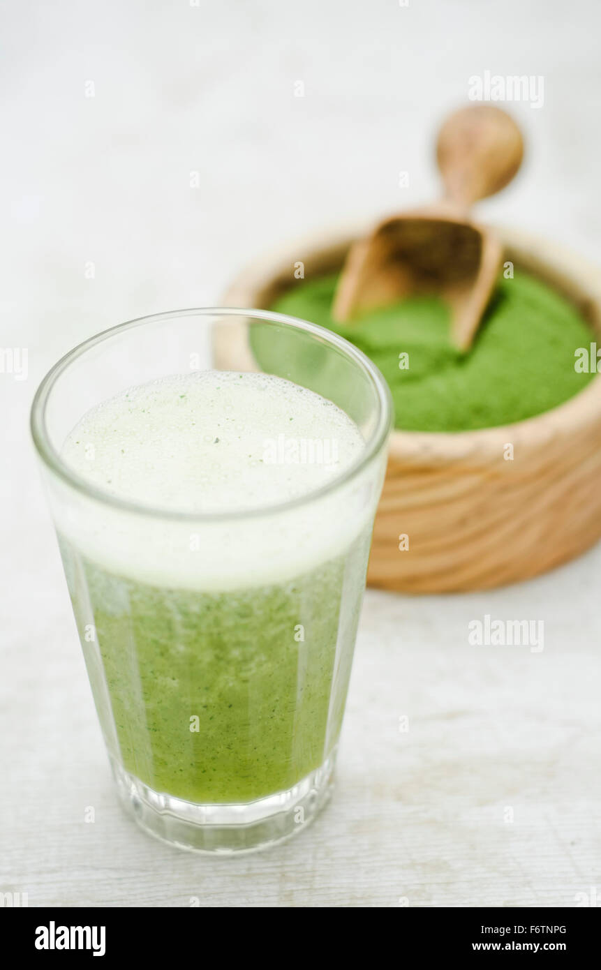 Moringa smoothie with orange and lemon juice, moringa powder in wooden ...