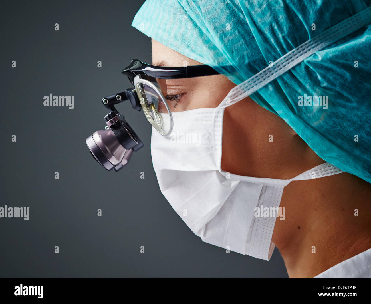 Young doctor wearing mask and magnifying spectacles Stock Photo - Alamy