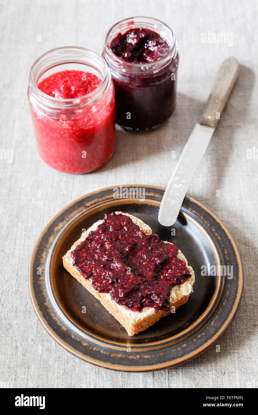 Homemade raspberry and blackberry jam with chia seeds, slice of bread ...
