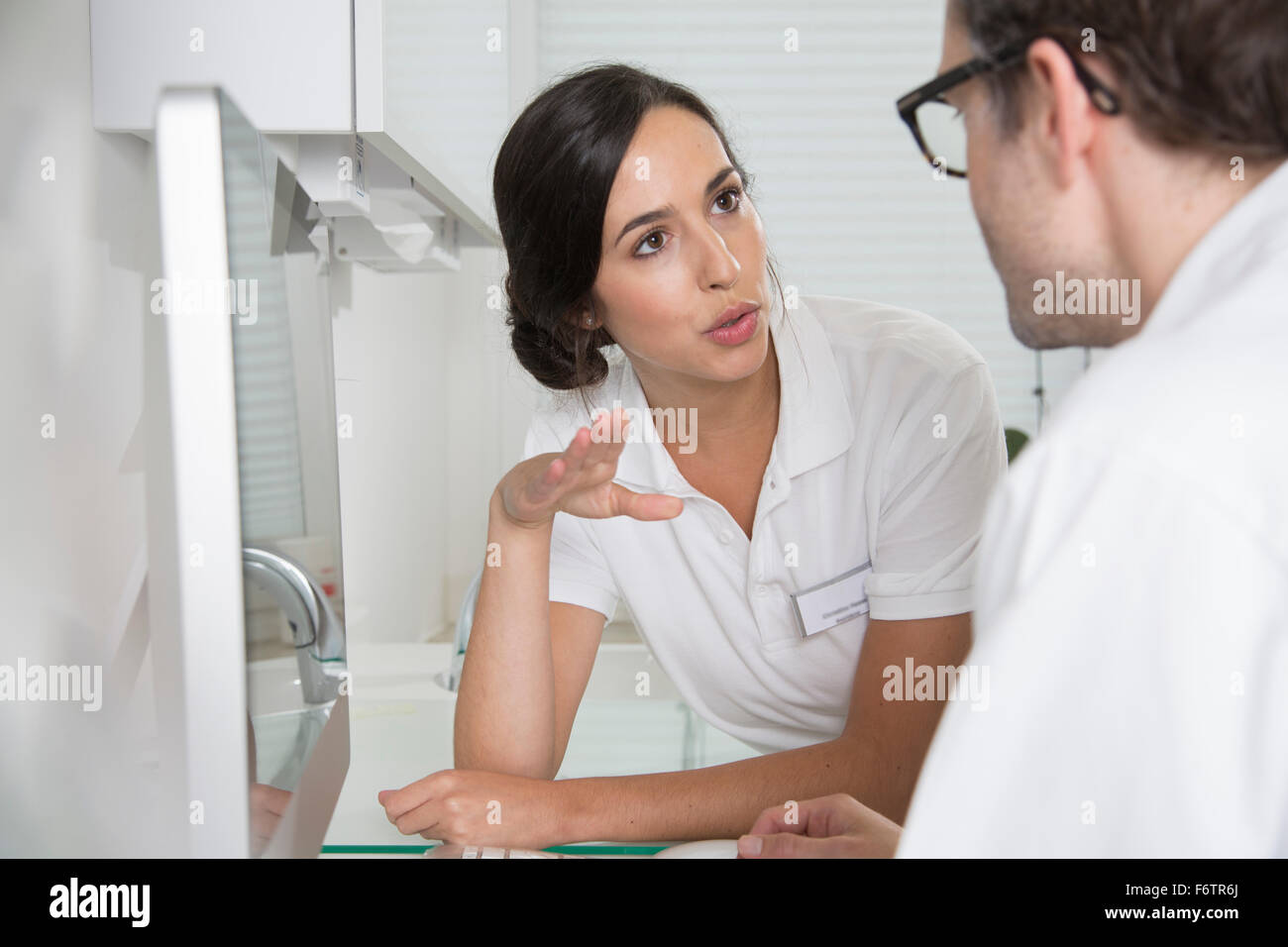 Two doctors at desk discussing Stock Photo - Alamy