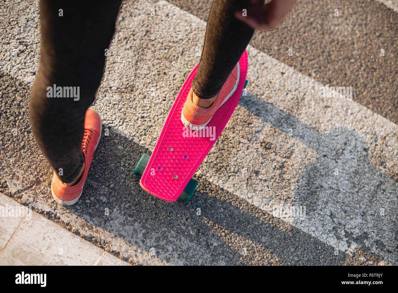 Skate boarder on zebra crossing, partial view Stock Photo - Alamy