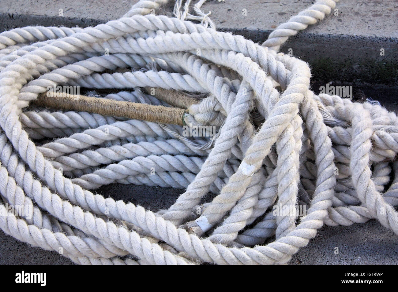 a pile of rope on the jetty Stock Photo - Alamy