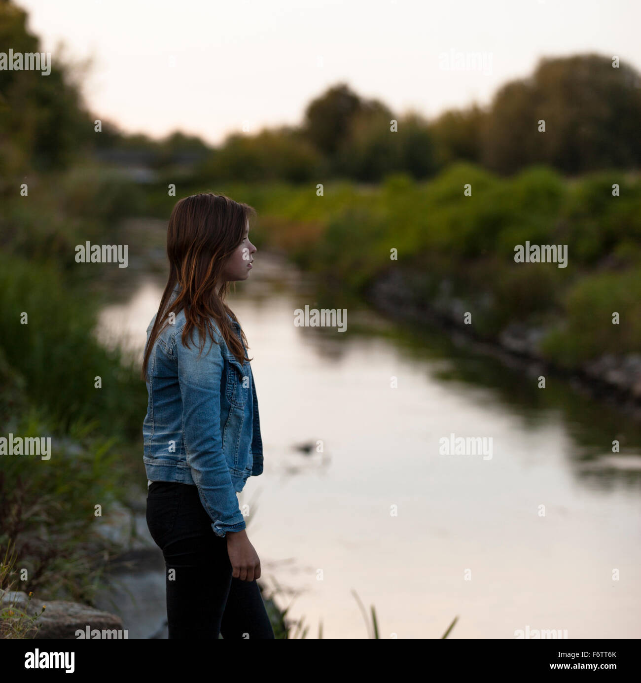 Portrait of teenage girl standing at riverside Stock Photo - Alamy