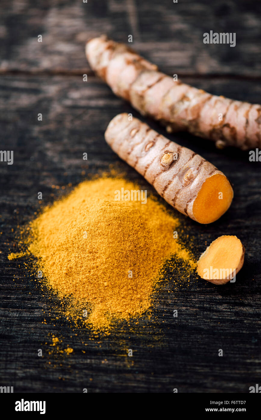 Fresh Curcuma and powder on wood Stock Photo - Alamy