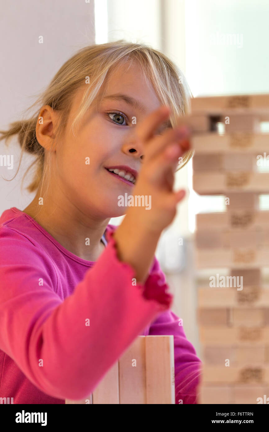 Little girl playing with building bricks Stock Photo - Alamy
