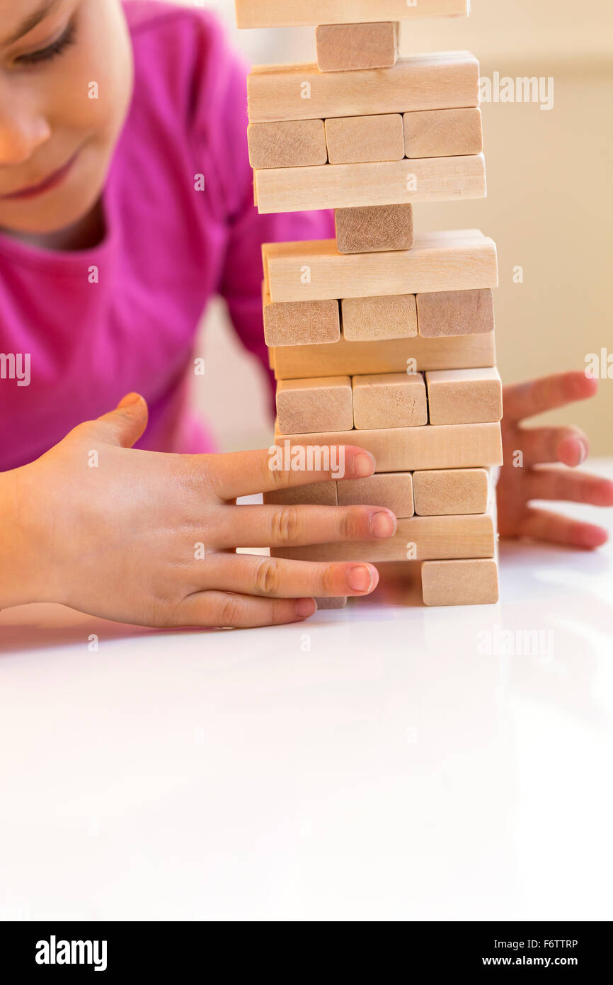 Little girl playing with building bricks Stock Photo - Alamy