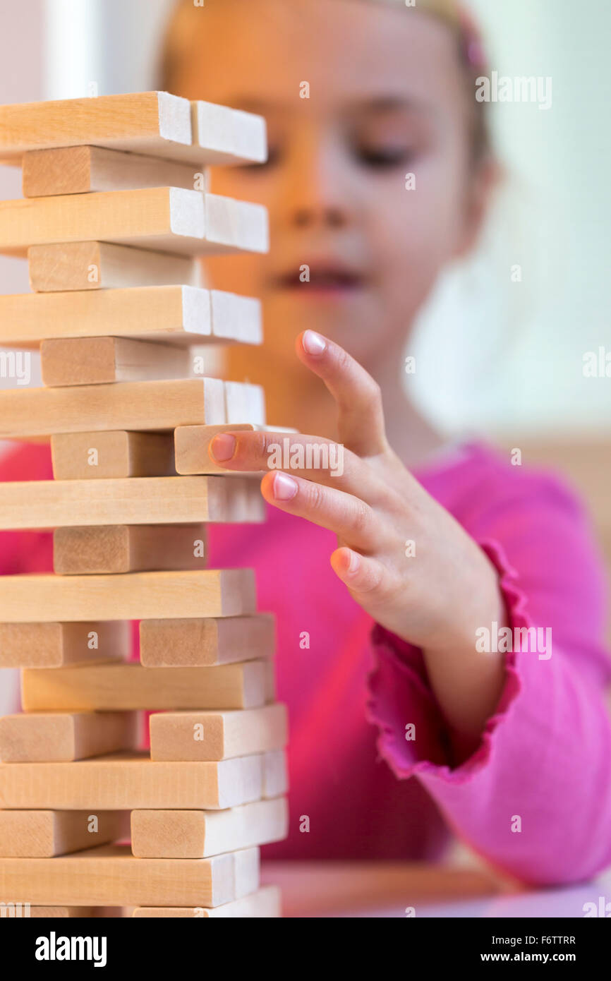 Little girl playing with building bricks Stock Photo - Alamy
