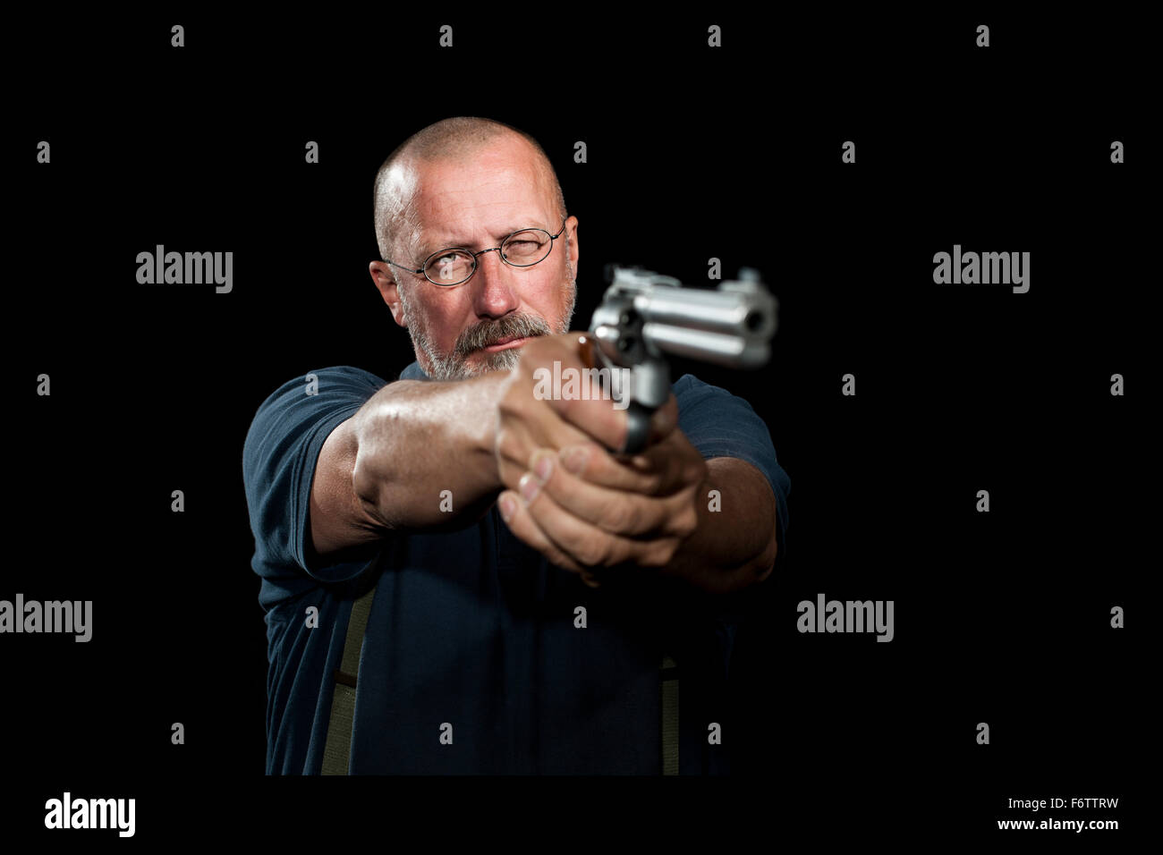 Mature man with revolver aiming Stock Photo - Alamy