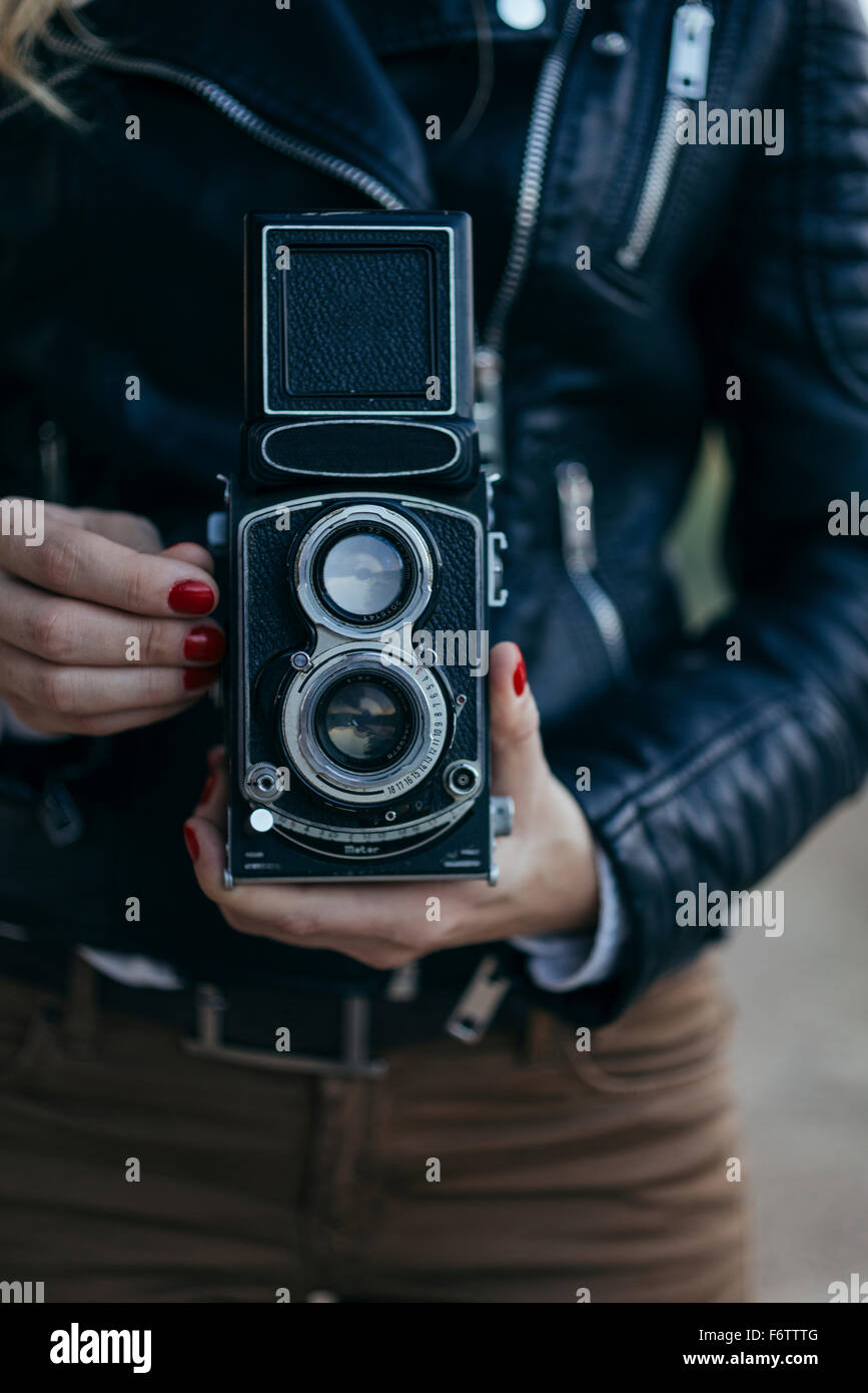 Woman using vintage camera, close-up Stock Photo - Alamy