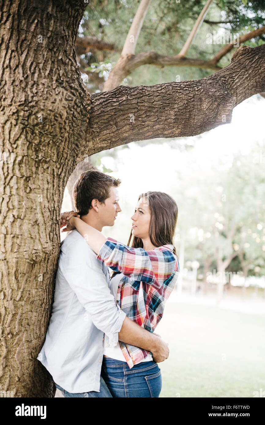 Young couple in love hugging in a park Stock Photo - Alamy