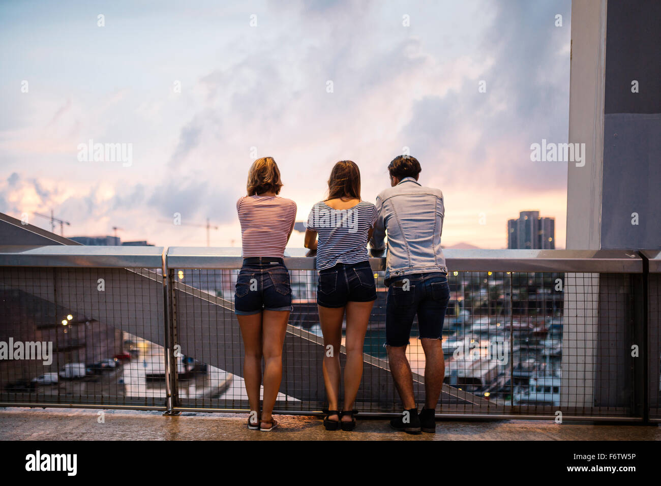 Rear view friends standing railing hi-res stock photography and images ...