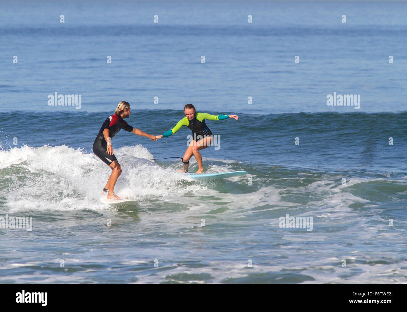 Surfer couple holding hands hi-res stock photography and images - Alamy