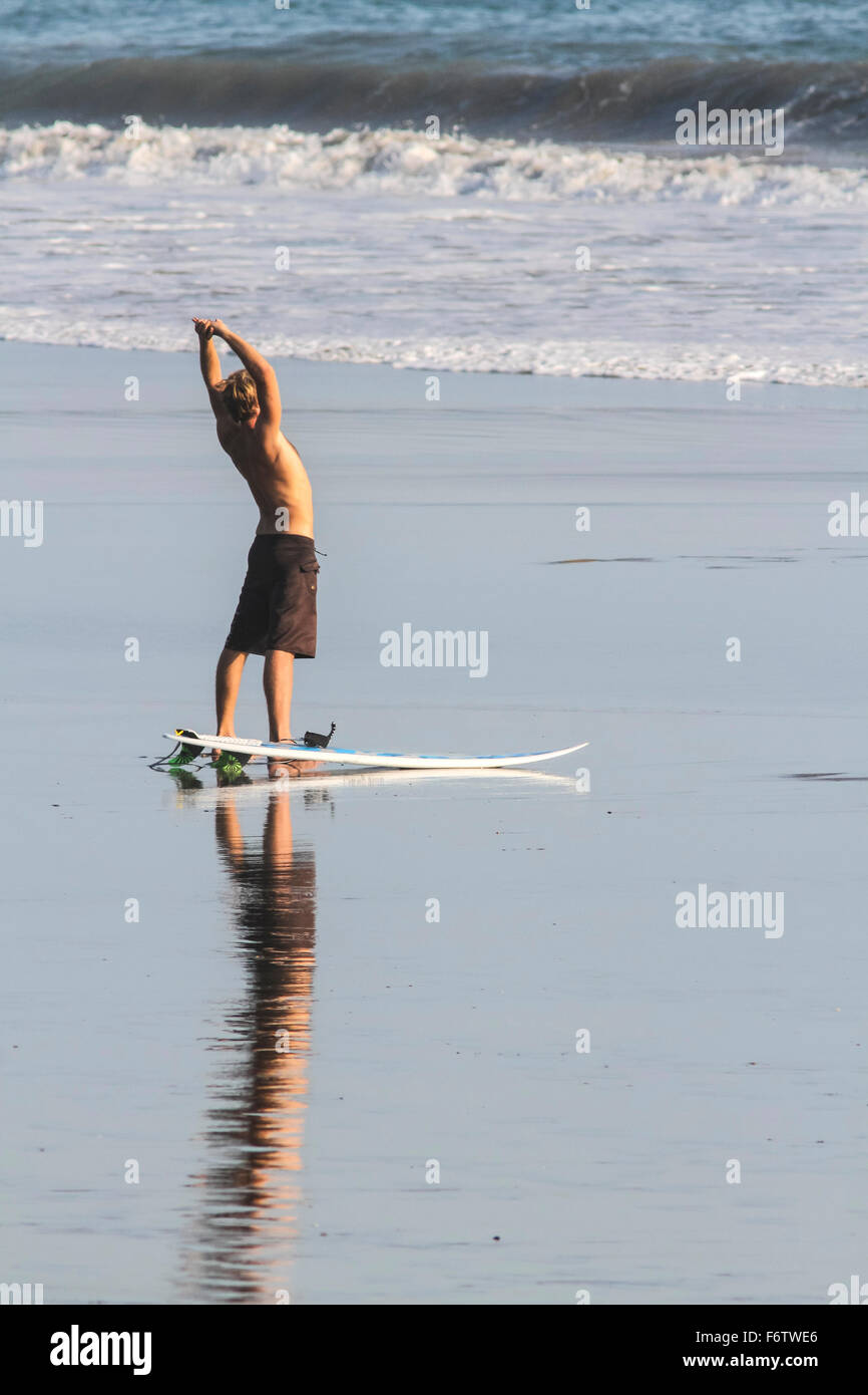 Indonesia, Bali, surfer stretching on the beach Stock Photo - Alamy