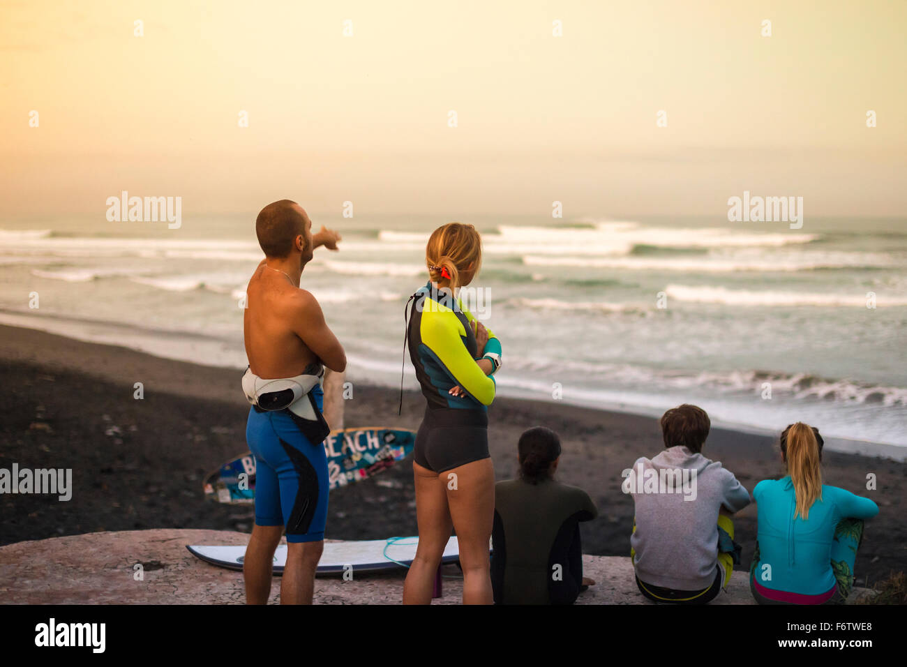 Indonesia, Bali, back view of five surfers on the beach looking to the ...