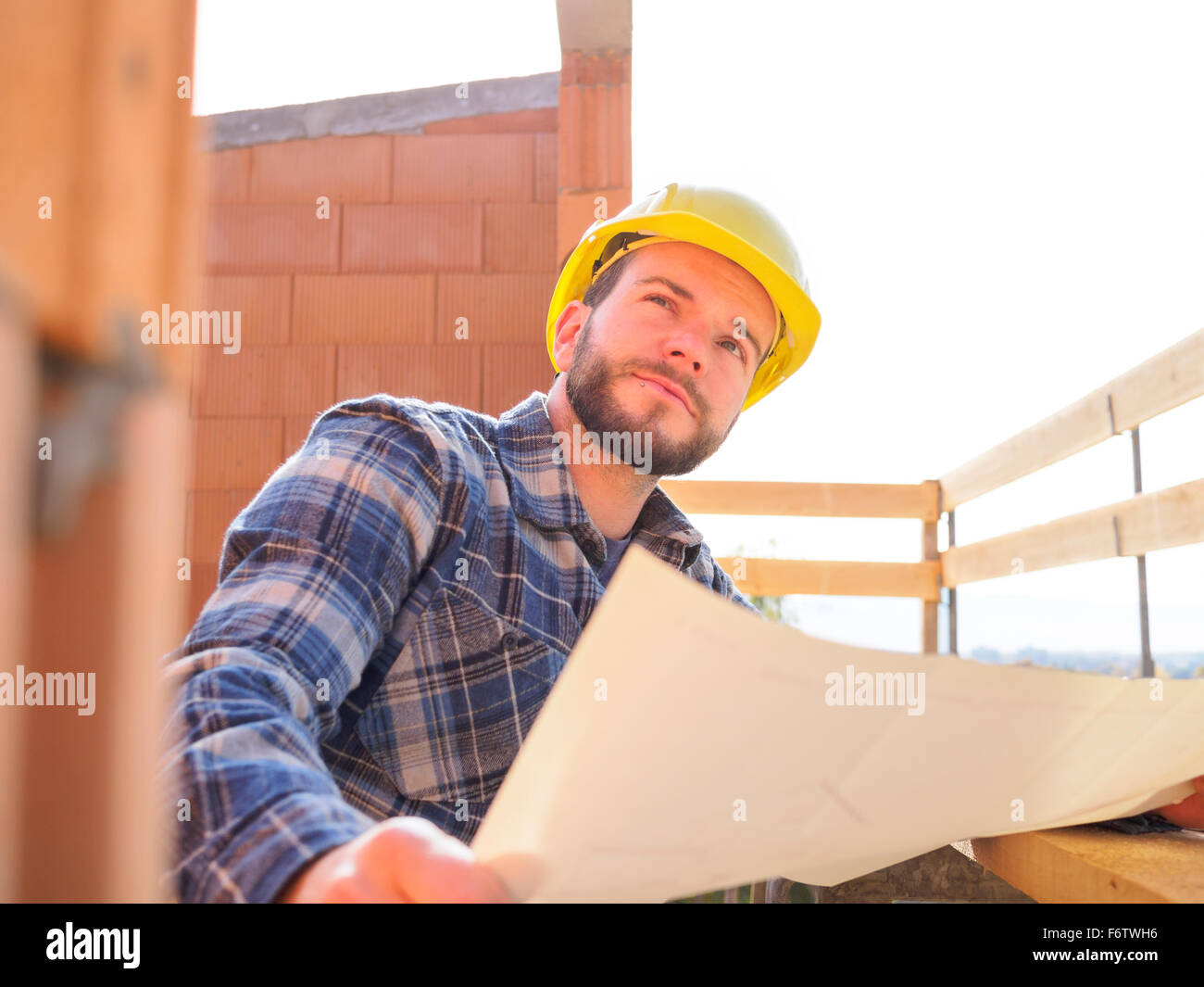 Portrait of foreman with construction plan Stock Photo - Alamy