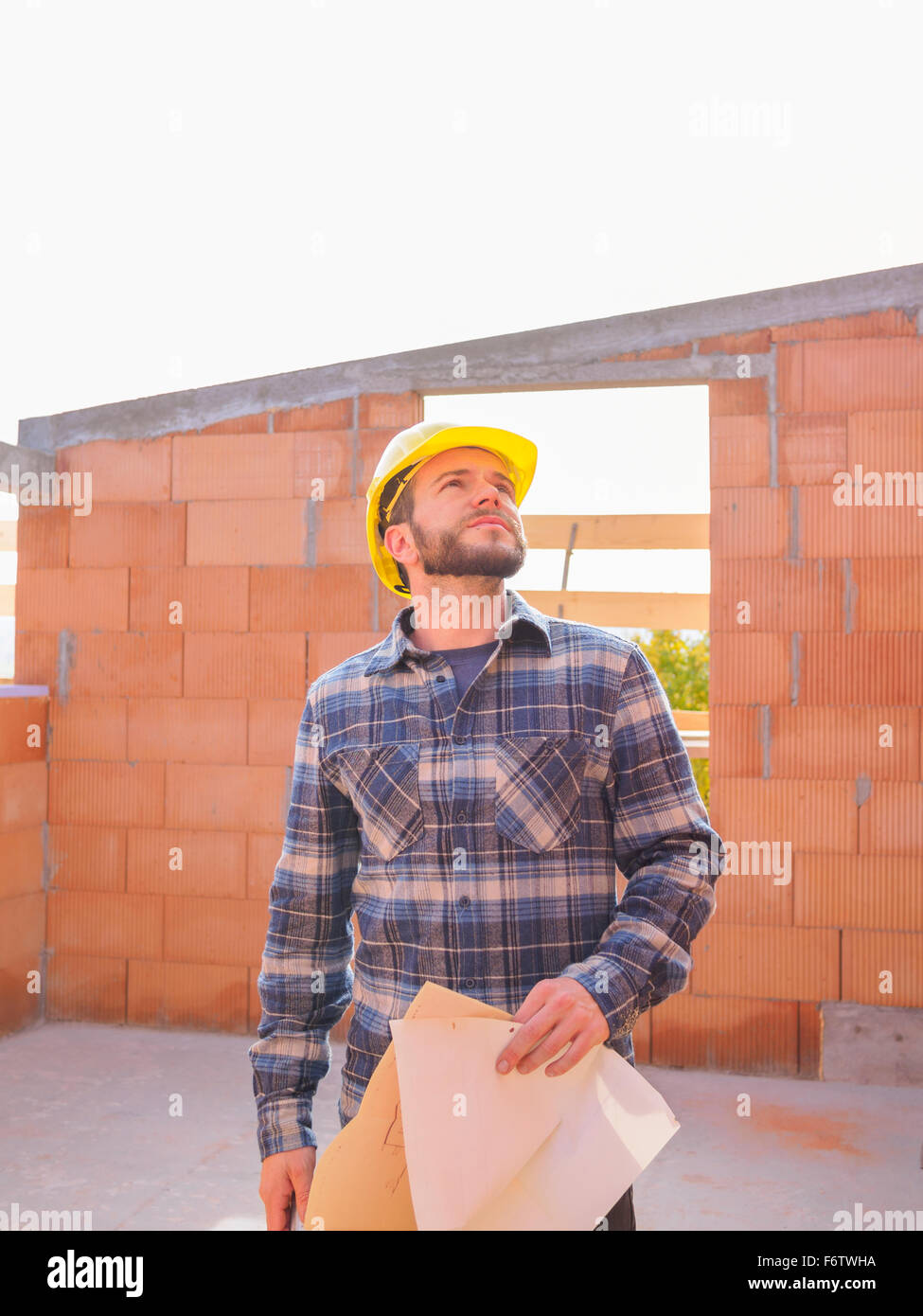Portrait of foreman with construction plan checking work at ...
