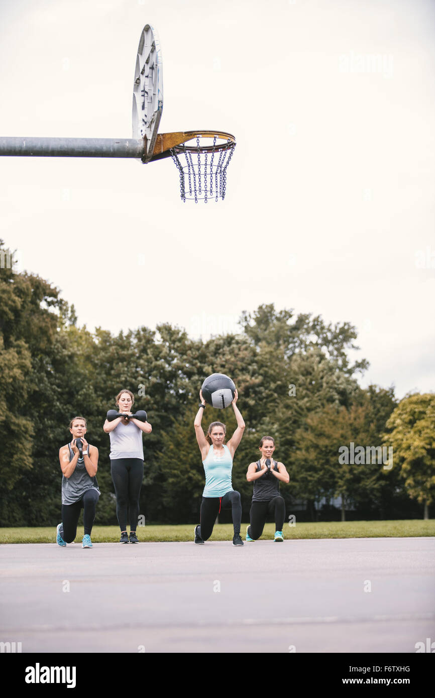Four women having an outdoor boot camp workout Stock Photo - Alamy