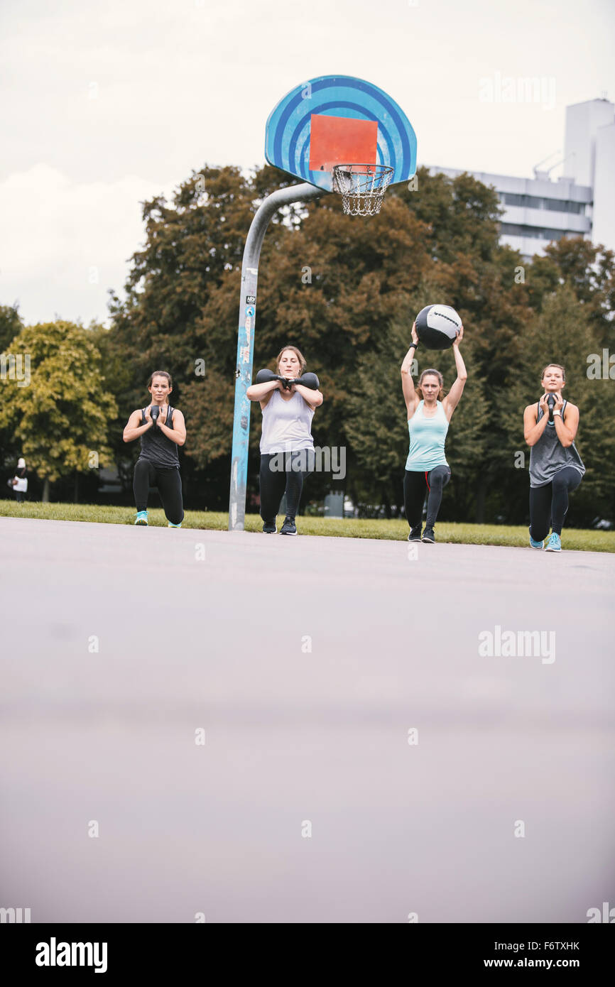 Four women having an outdoor boot camp workout Stock Photo - Alamy